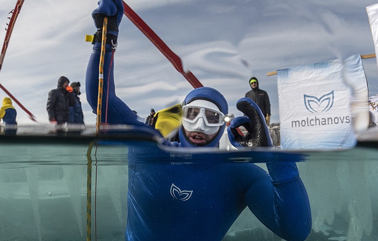 Deepest dive under ice - breath held (fins and diving suit) by a male ...